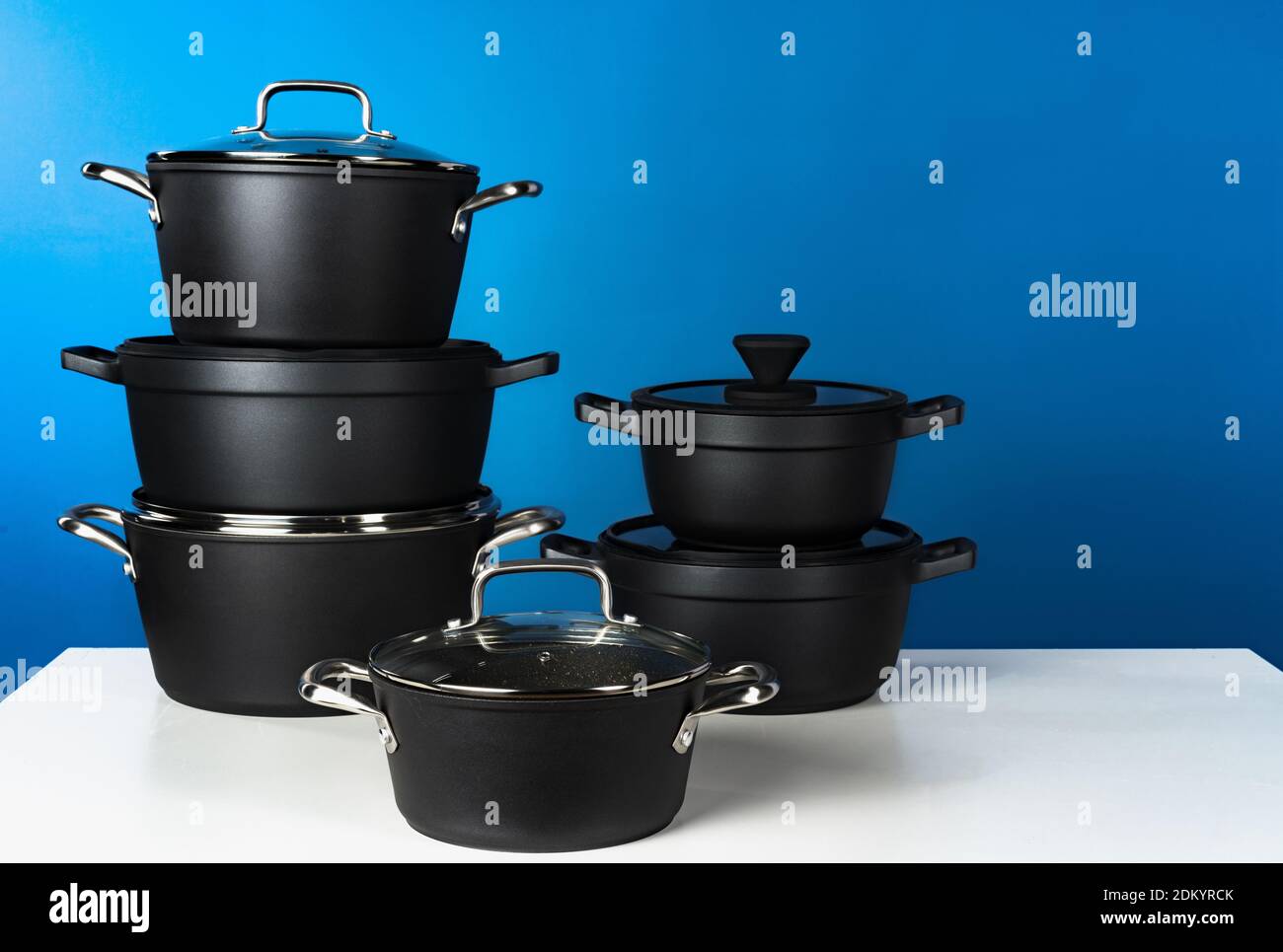 Set of black cookware against blue background Stock Photo - Alamy