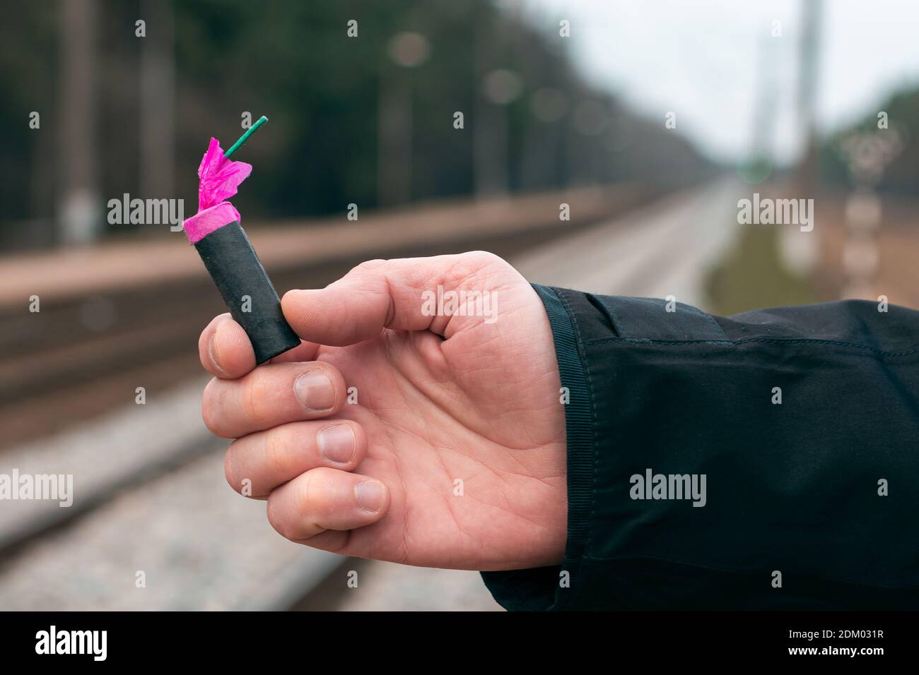 The Firecracker in a Hand. Man Holding a Black Petard in His Hand. A ...