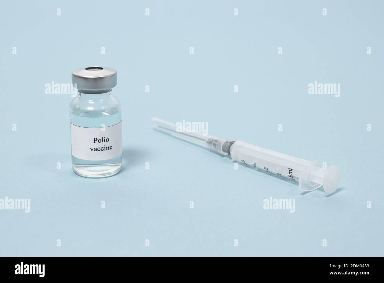 Polio vaccine and syringe on a blue background. Vaccination and ...