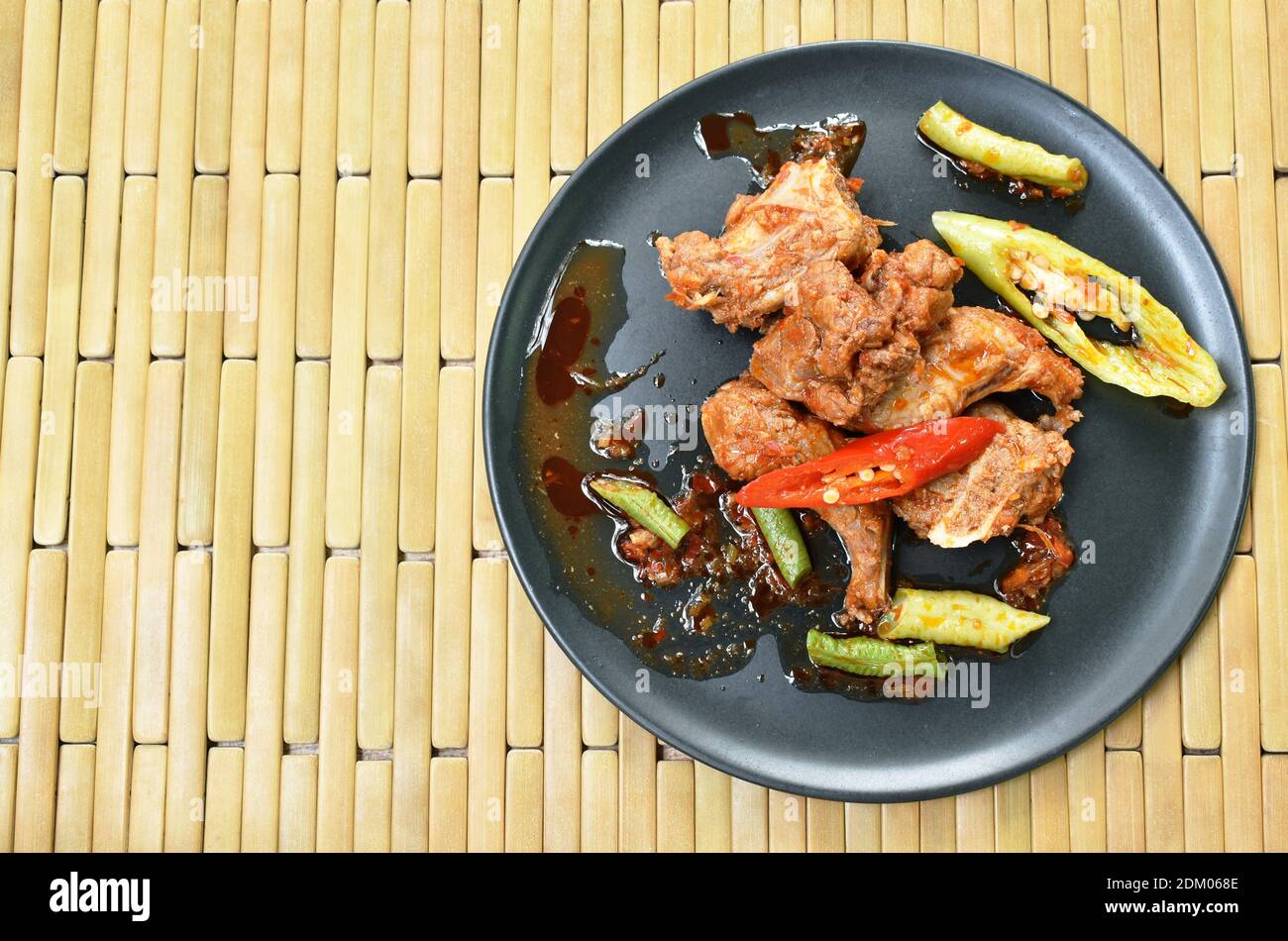 spicy stir fried pork bone with chili and Chinese long bean on plate ...
