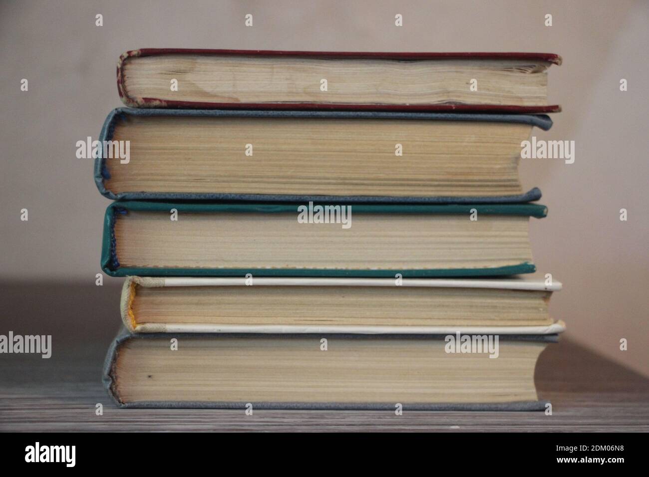 Five books on old table egde. Knowledge conceptfocus selected Stock ...