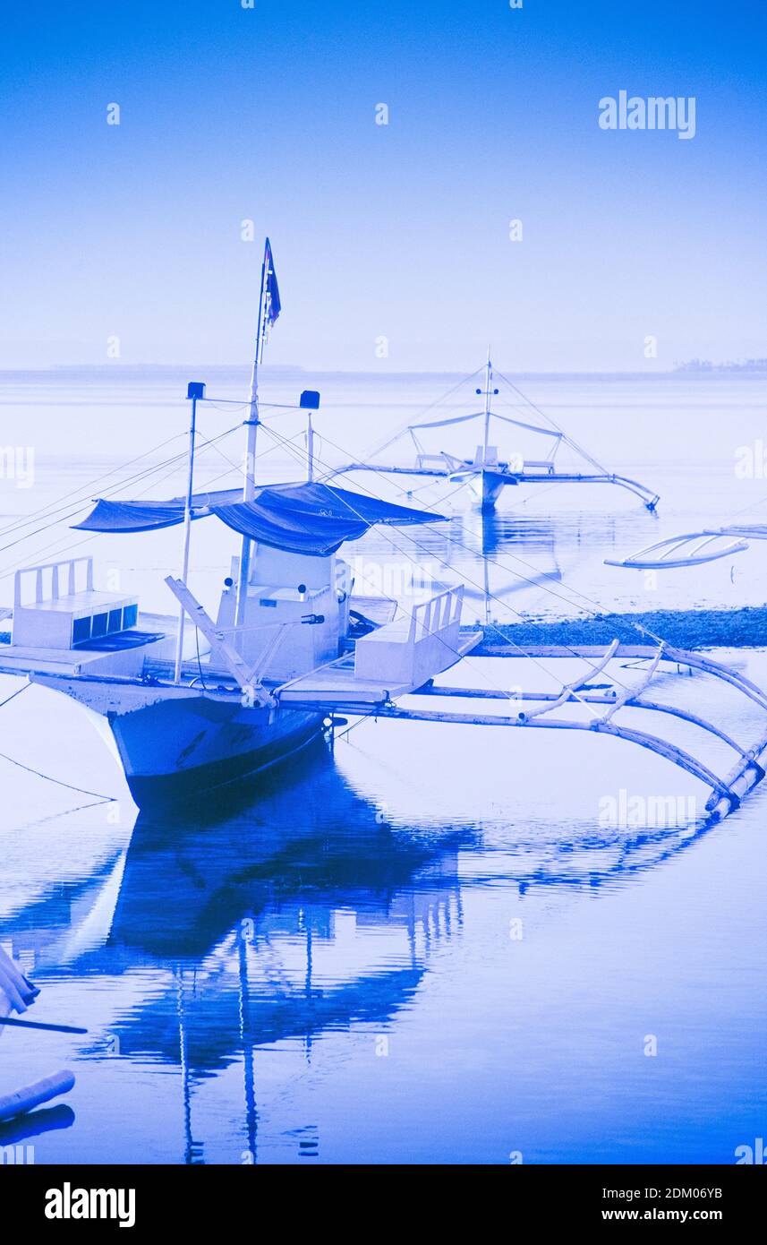 Traditional Filipino outrigger fishing boats, known as 'bangka' boats ...