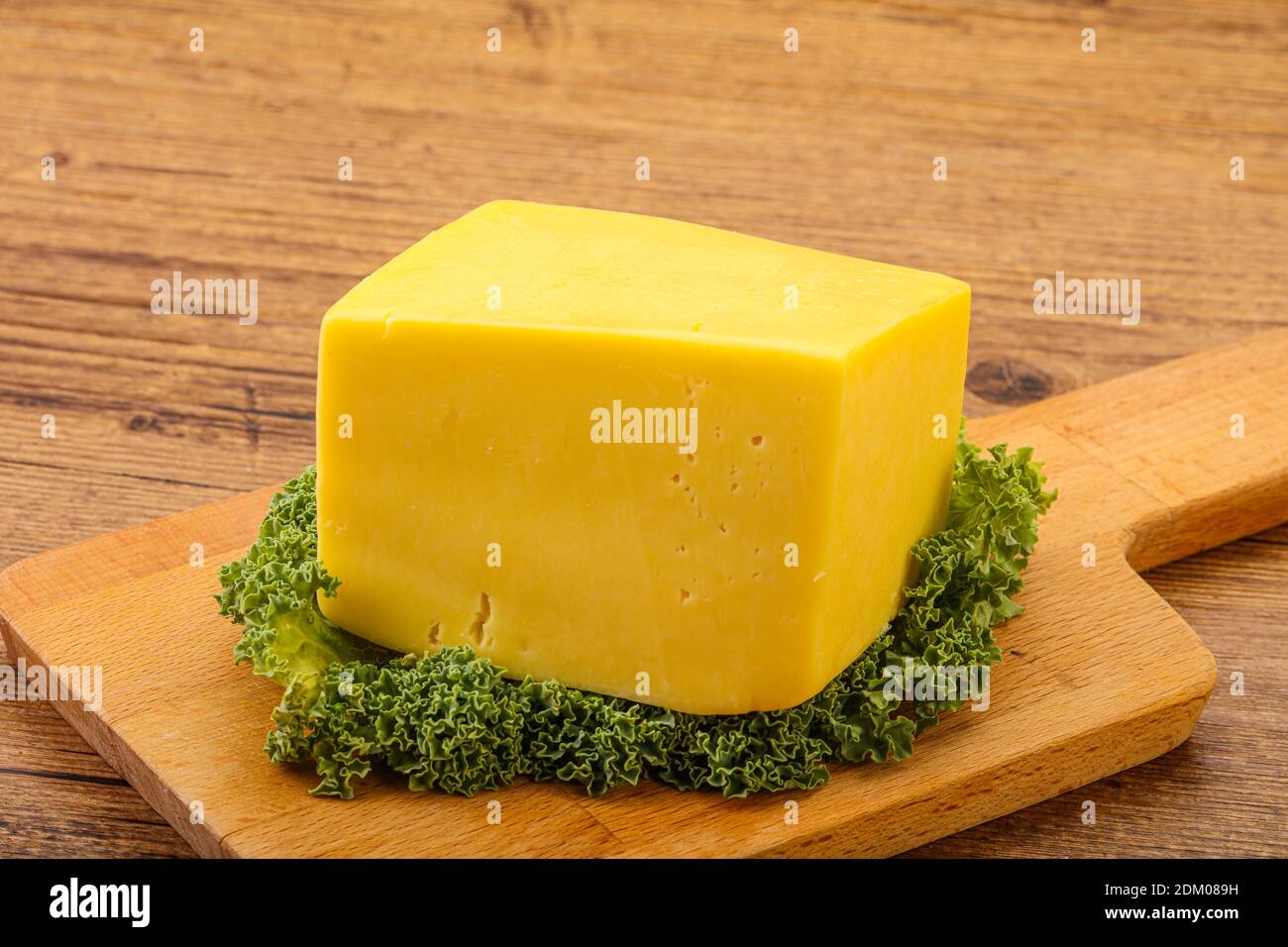 Yellow tilsiter cheese dairy product brick Stock Photo - Alamy