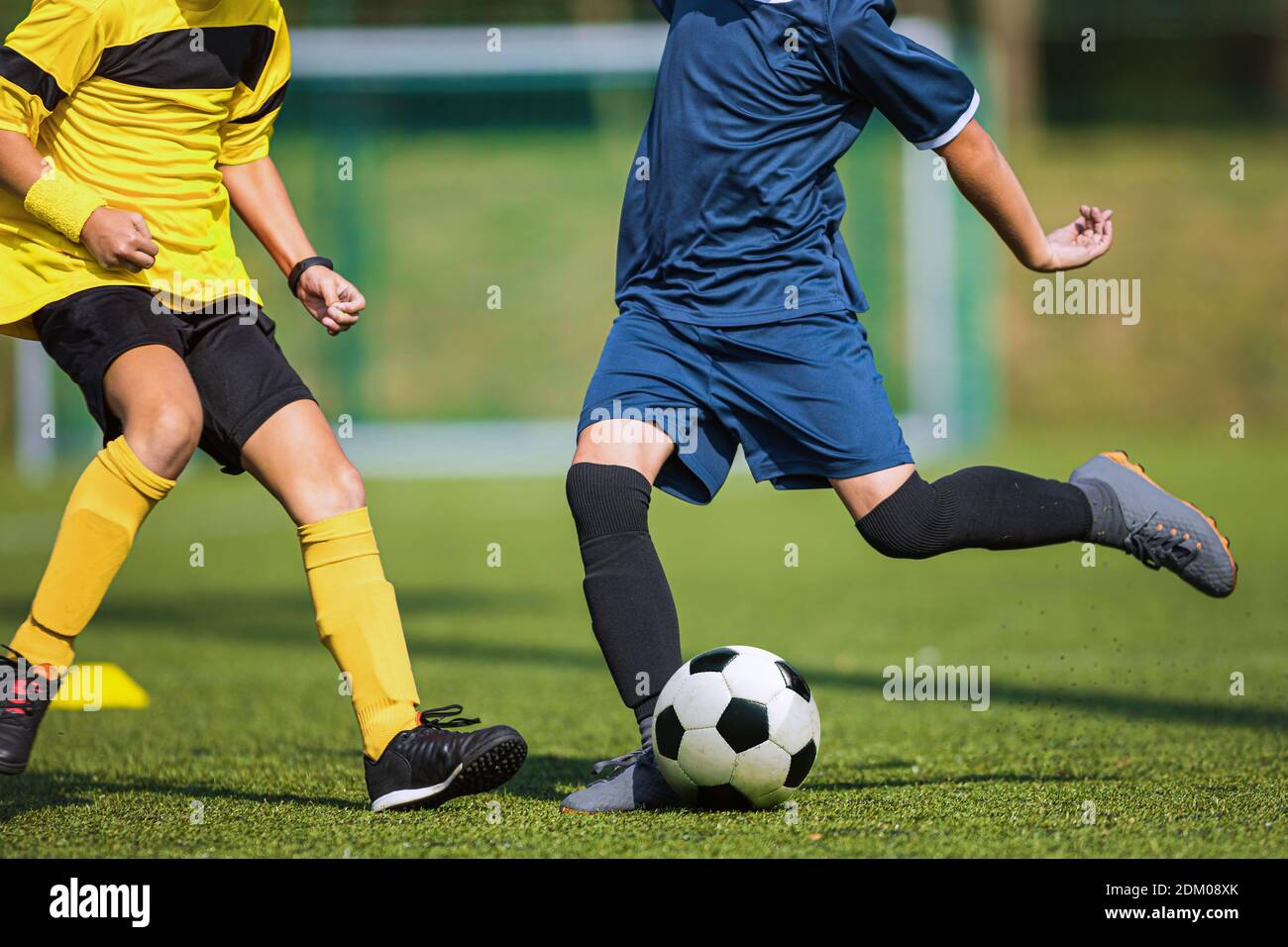 Two soccer players compete in a duel. Footballers kicking ball. Players ...