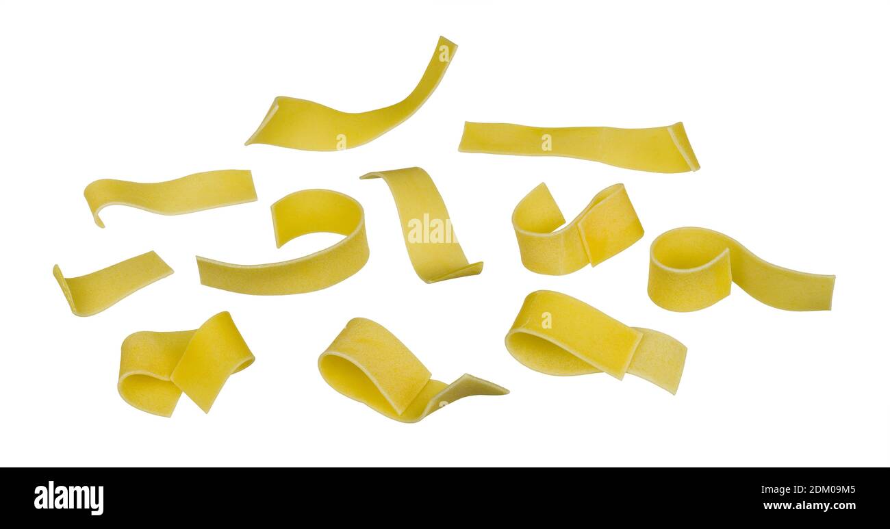 Set of separated raw wide pasta noodles isolated on white background ...
