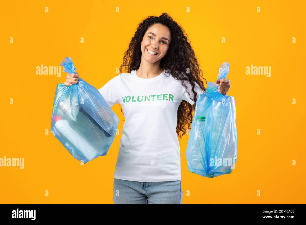 Volunteer Lady Holding Blue Plastic Garbage Bags Over Yellow Background ...