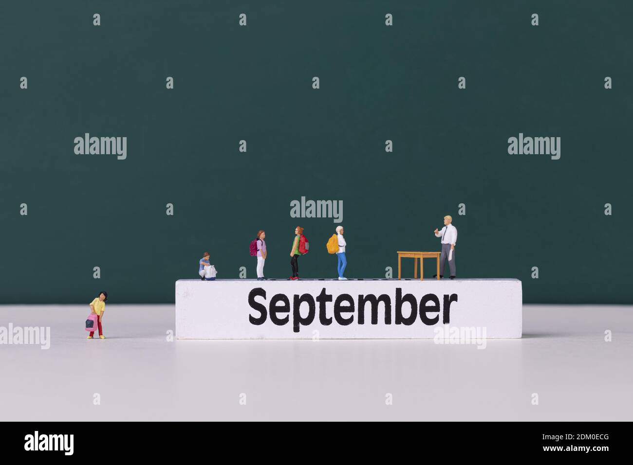 A teacher and student figurines around the September calendar - first ...