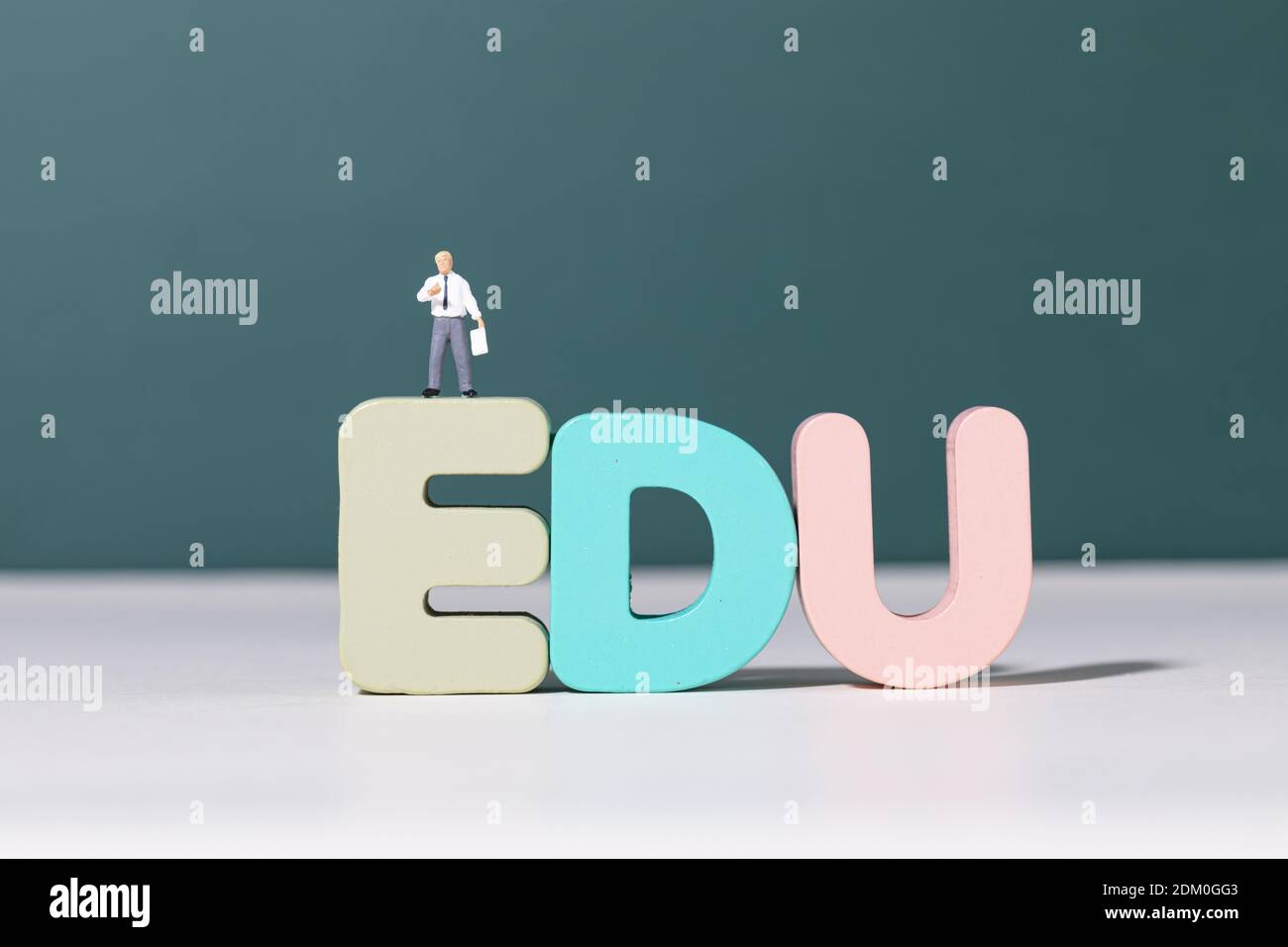 A view of teacher figurine standing on EDU letters Stock Photo - Alamy