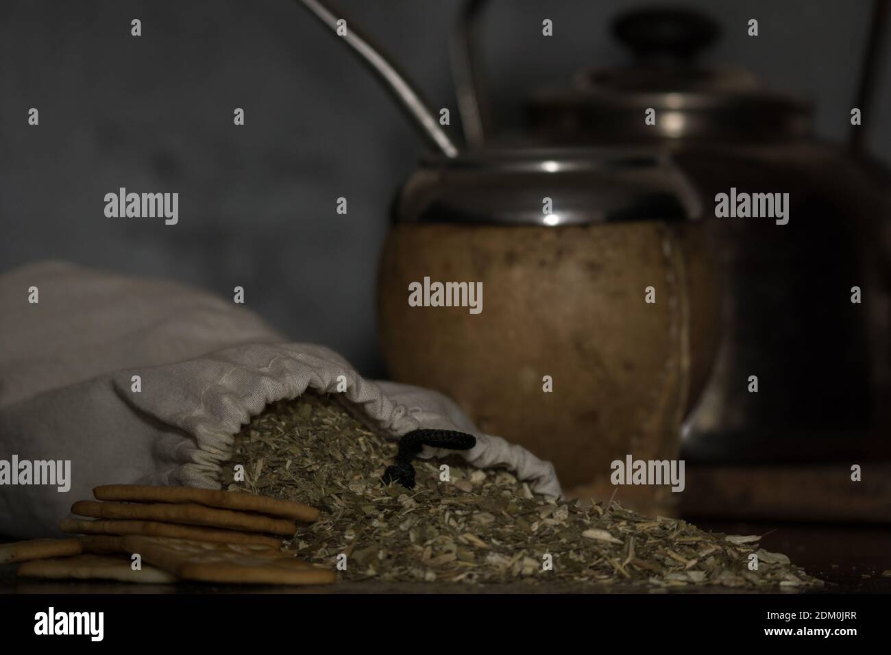 A shot of a brown calabash, a kettle and a bag filled with tea herb ...