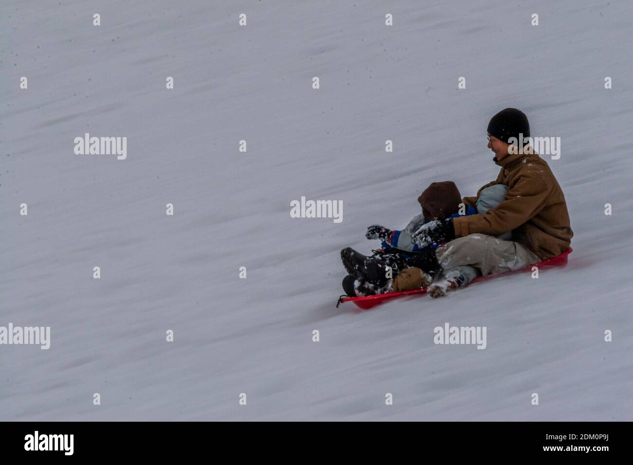Father son sledding winter entertainment hi-res stock photography and ...
