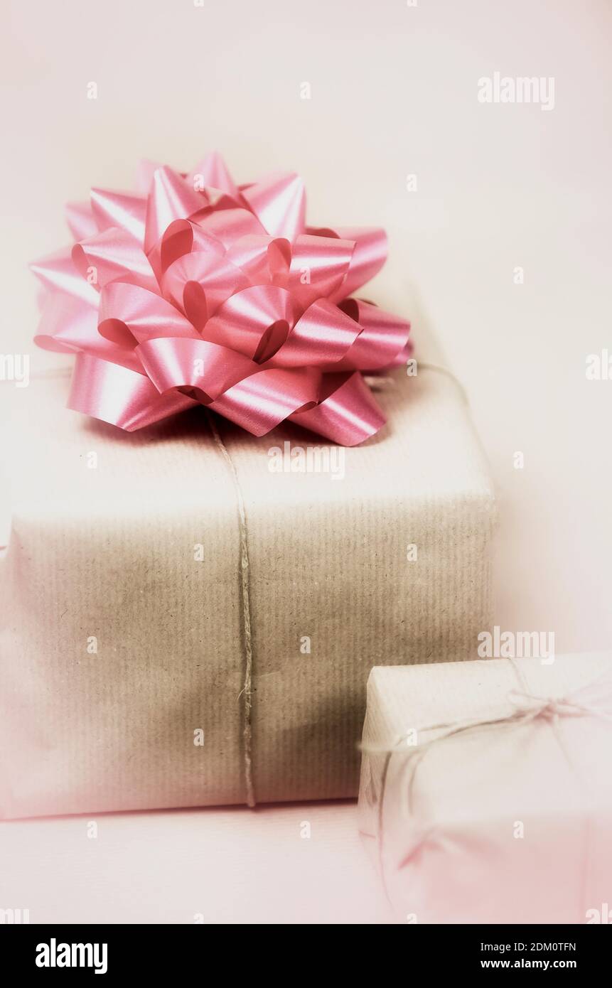 Two gift boxes in romantic pink design, decorated with ribbons and bows ...