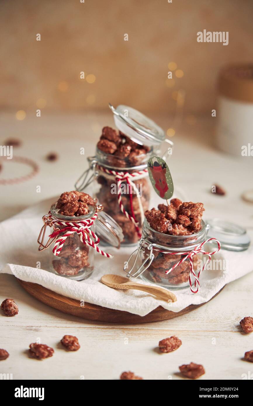 A vertical shot of delicious Christmas roasted almonds in a jar on a ...