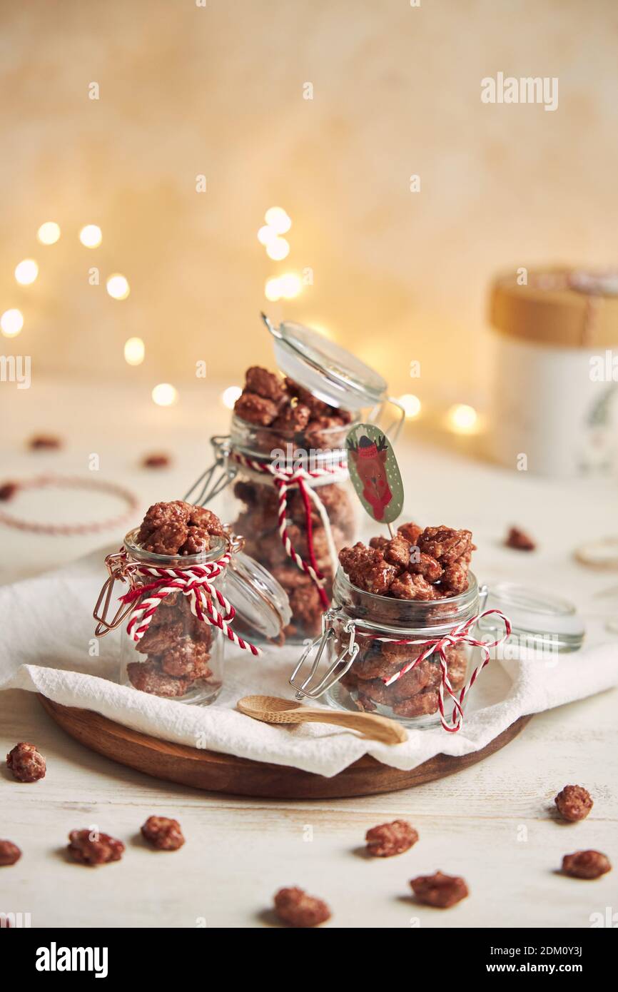 A vertical shot of delicious Christmas roasted almonds in a jar on a ...