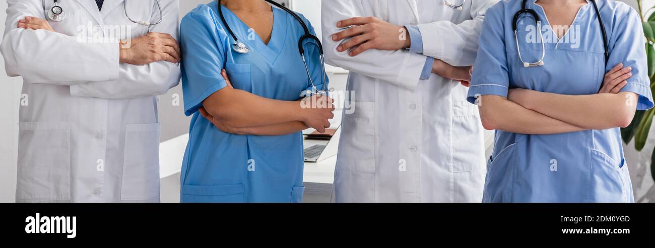Cropped view of multicultural nurses and doctors with crossed arms ...