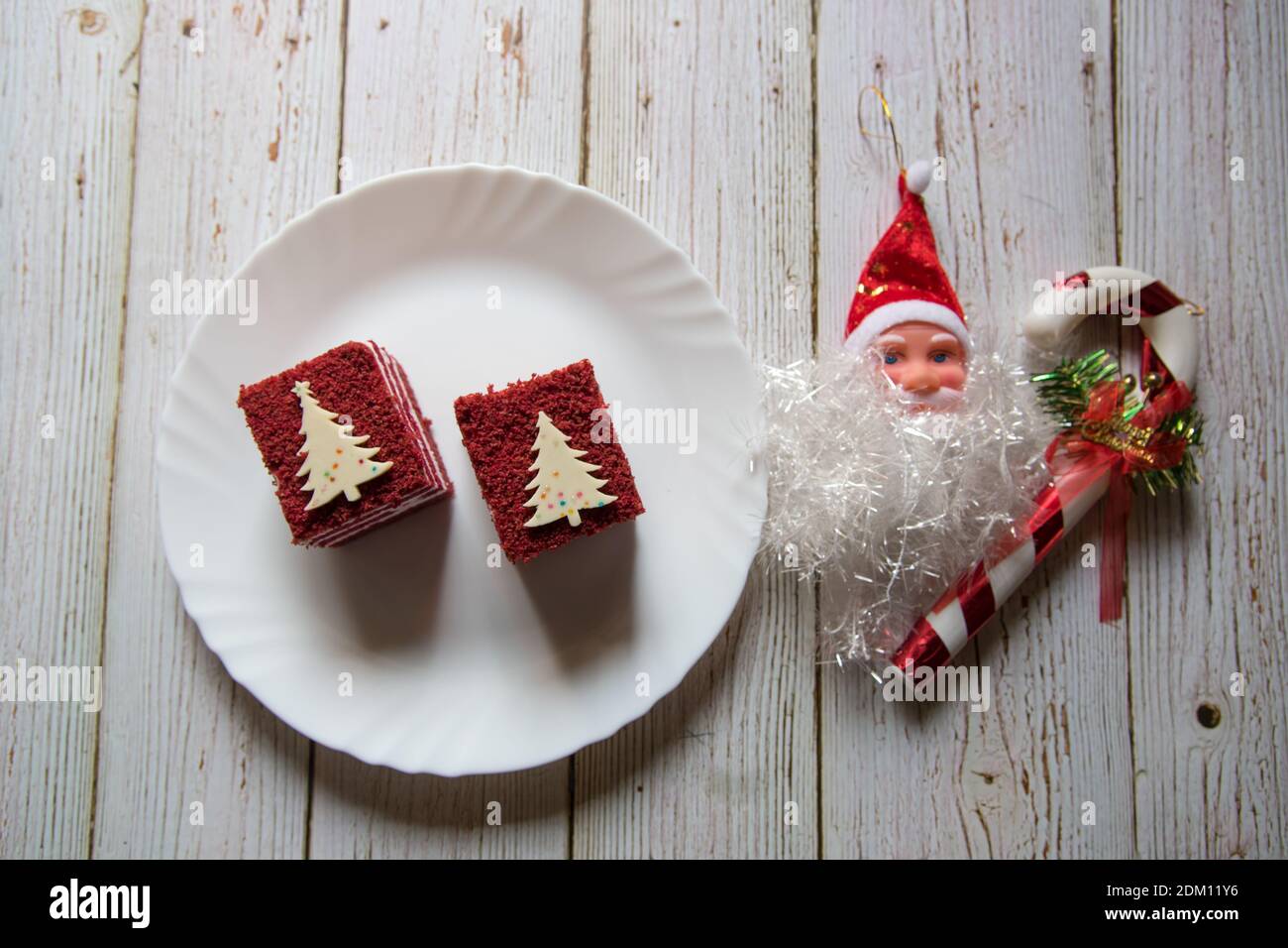 Red velvet cake with Christmas tree and Santa Claus Stock Photo - Alamy