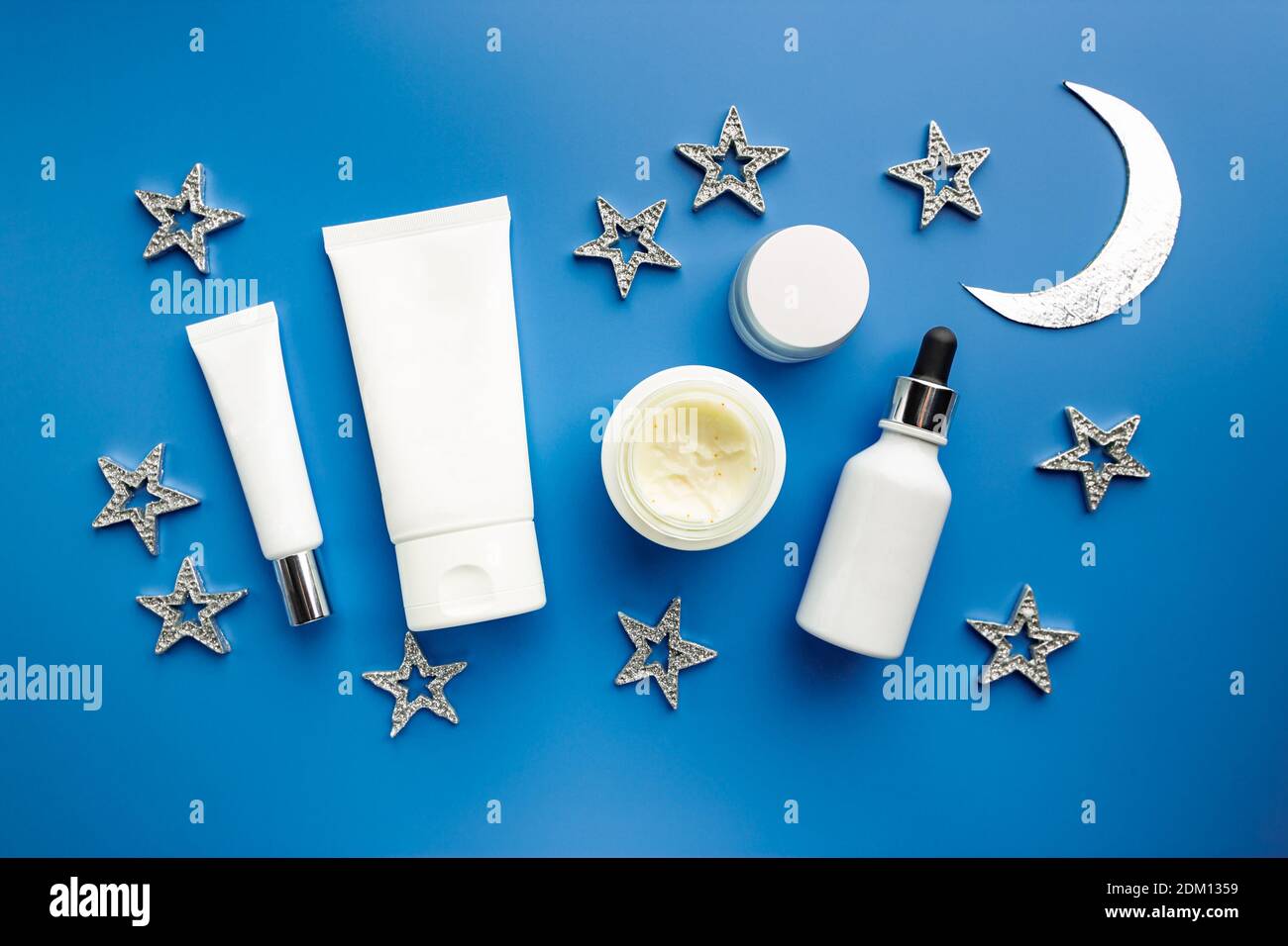 Cosmetic white containers on blue background top view. Skin care ...