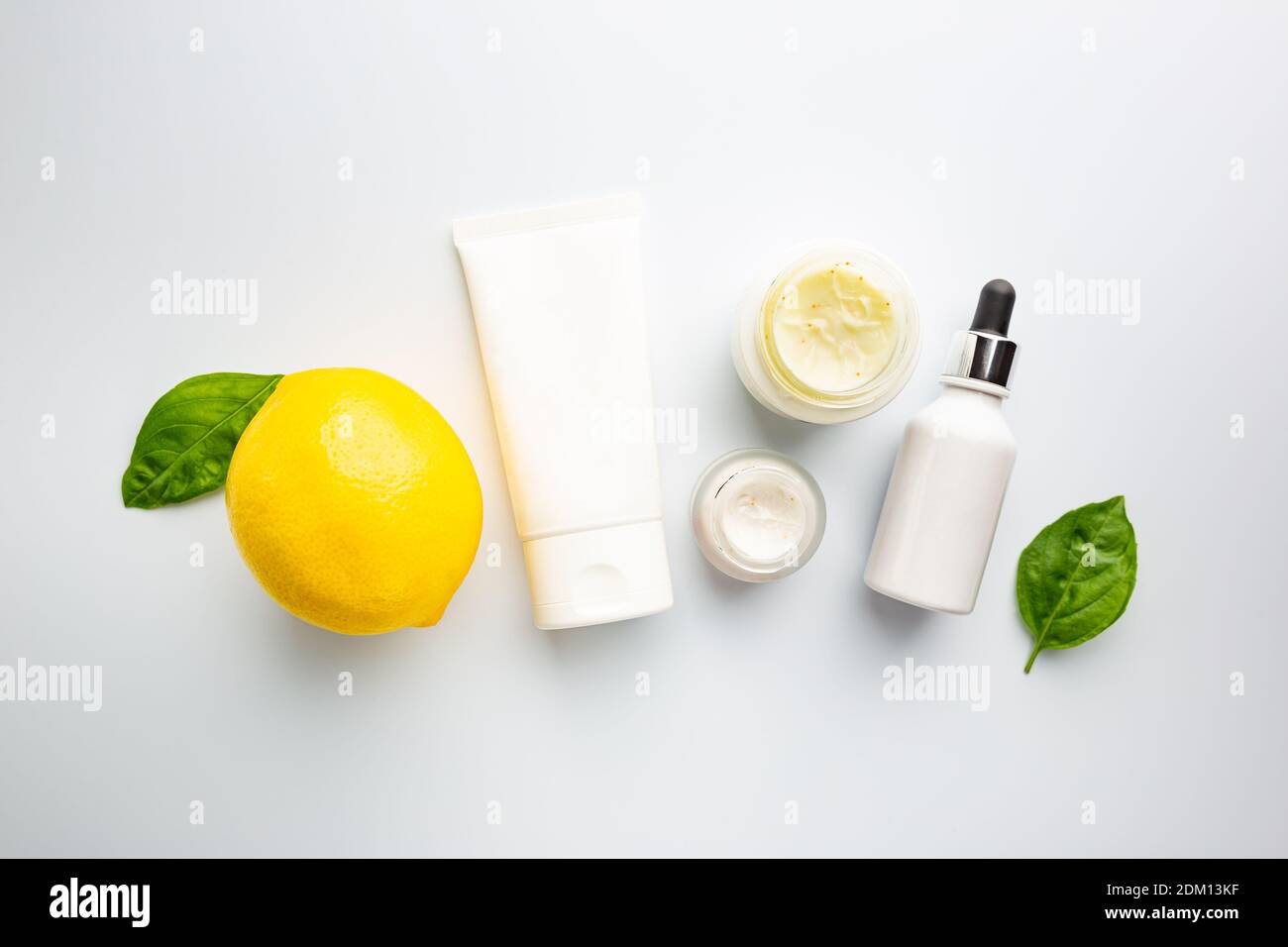 Flat lay composition with skin care products and lemon fruit on white ...