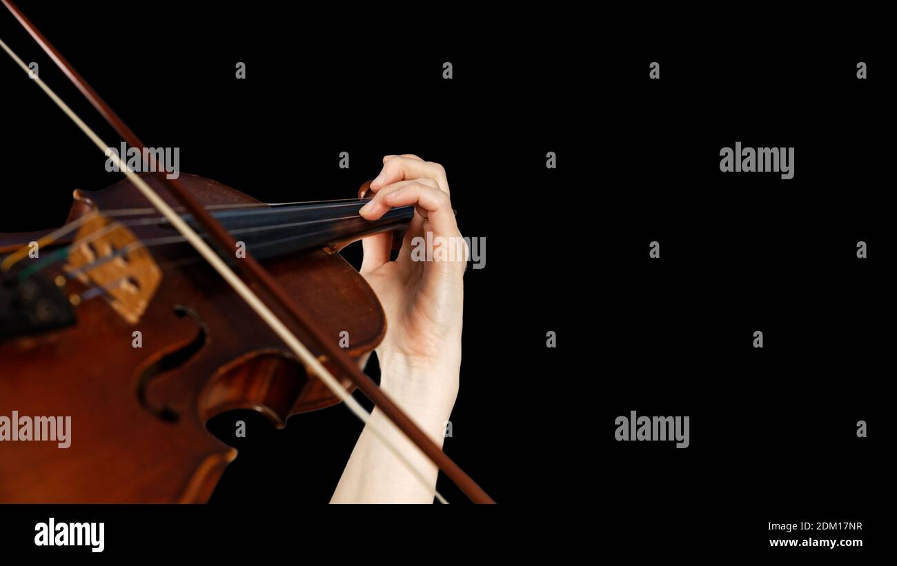Closeup violin, bow and hand of player on the strings of a violin ...