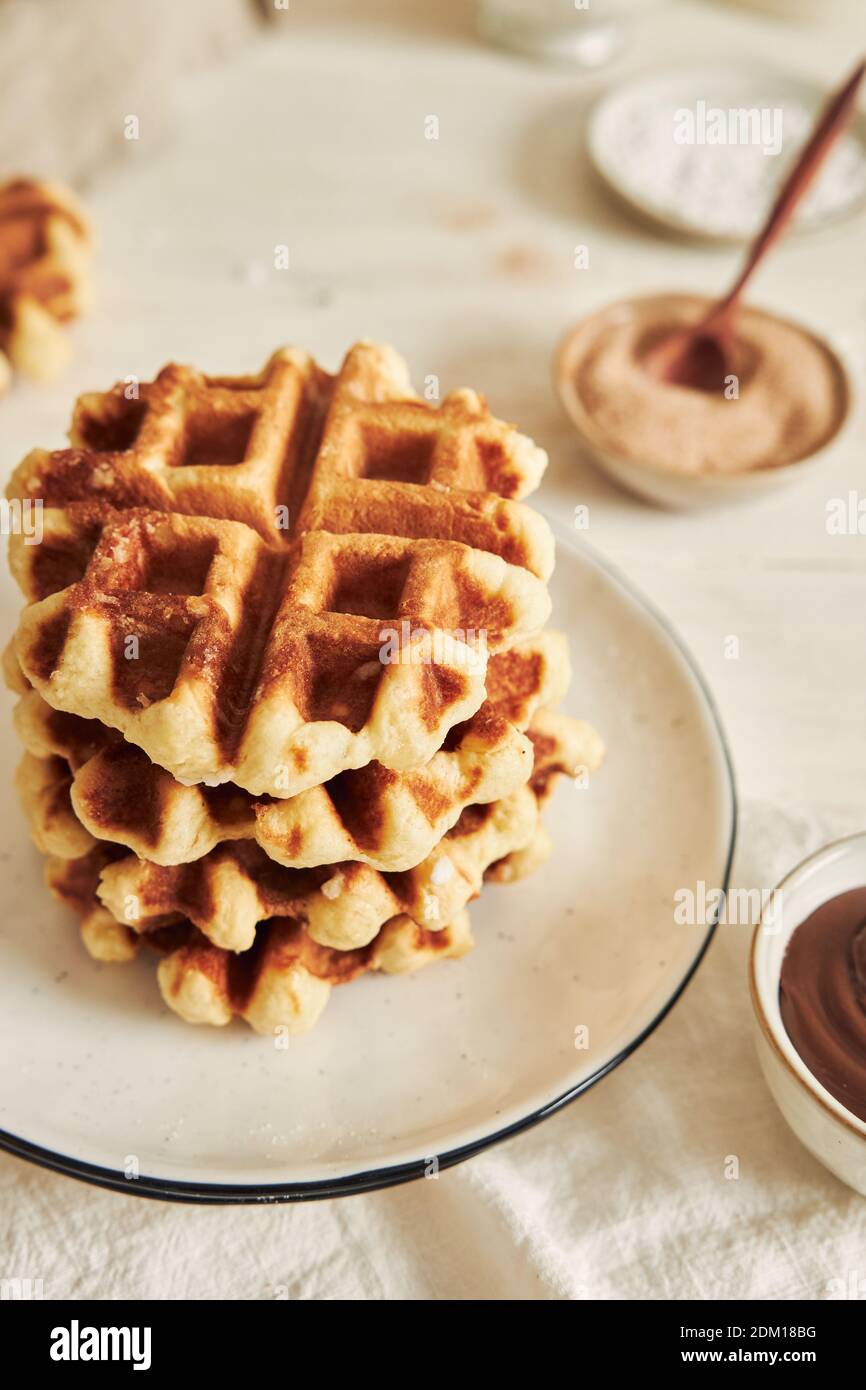 A vertical shot of delicious Waffles with chocolate dip on a white ...