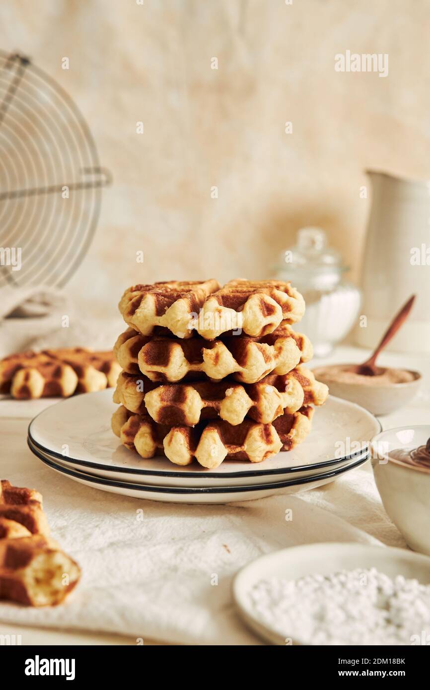 A vertical shot of delicious waffles in a pi on a white table Stock ...