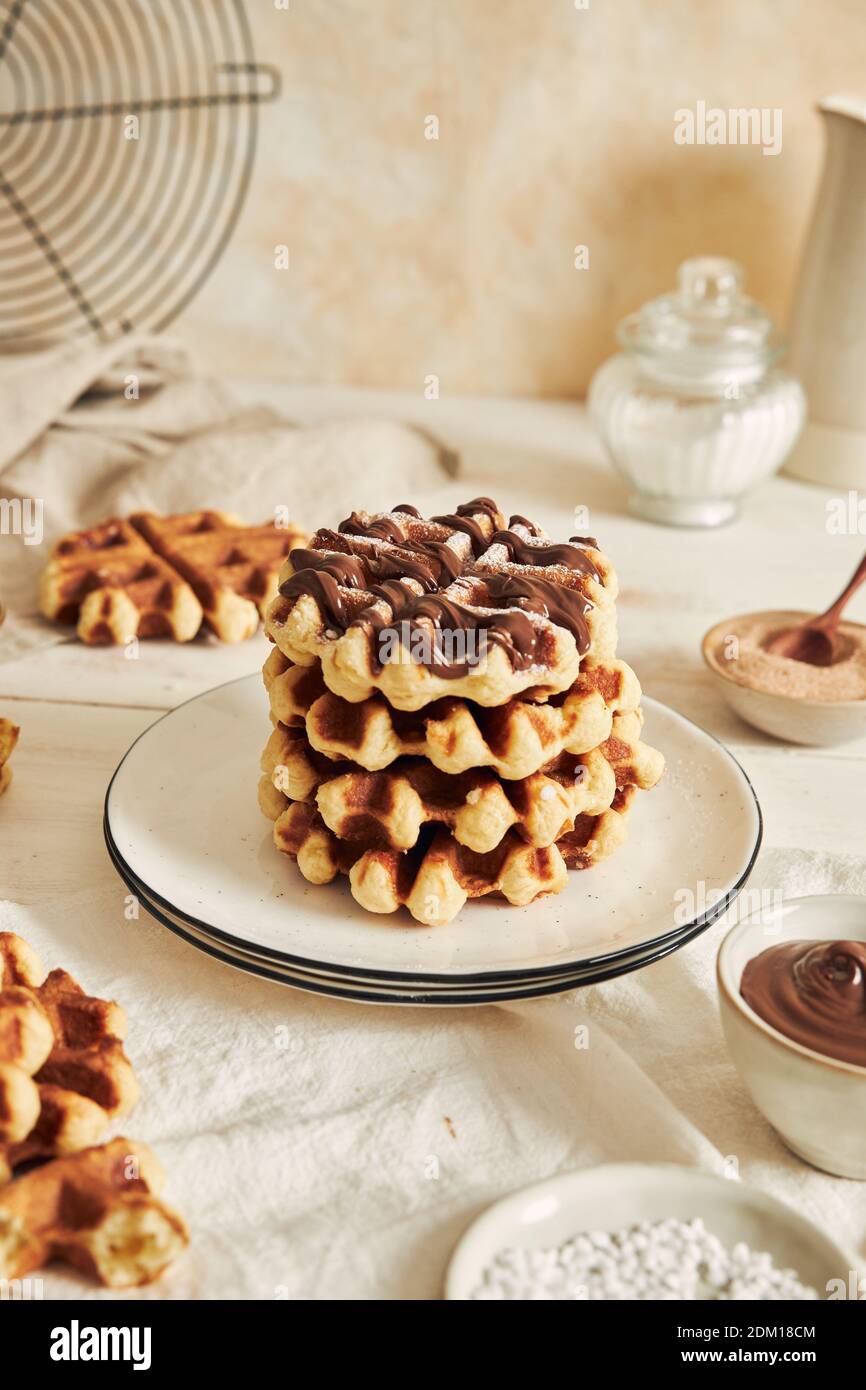 A vertical shot of delicious Waffles with chocolate dip on a white ...