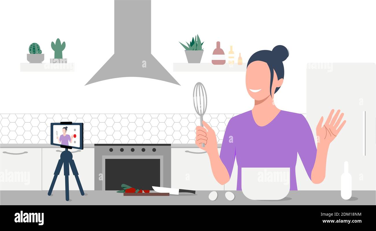 A young smiling woman cooking and recording live video for social ...