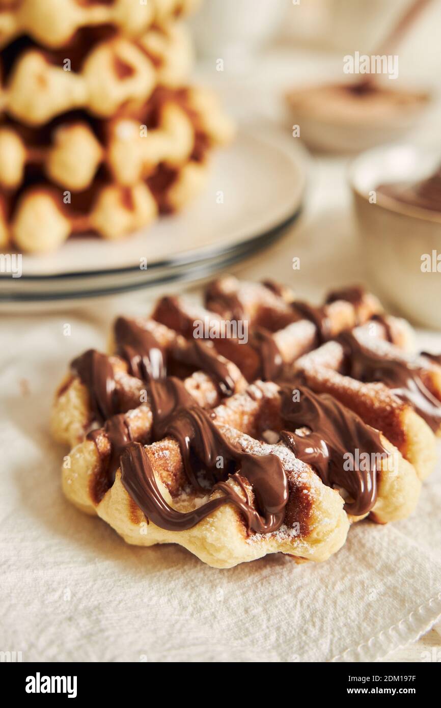 A vertical shot of delicious Waffles with chocolate dip on a white ...