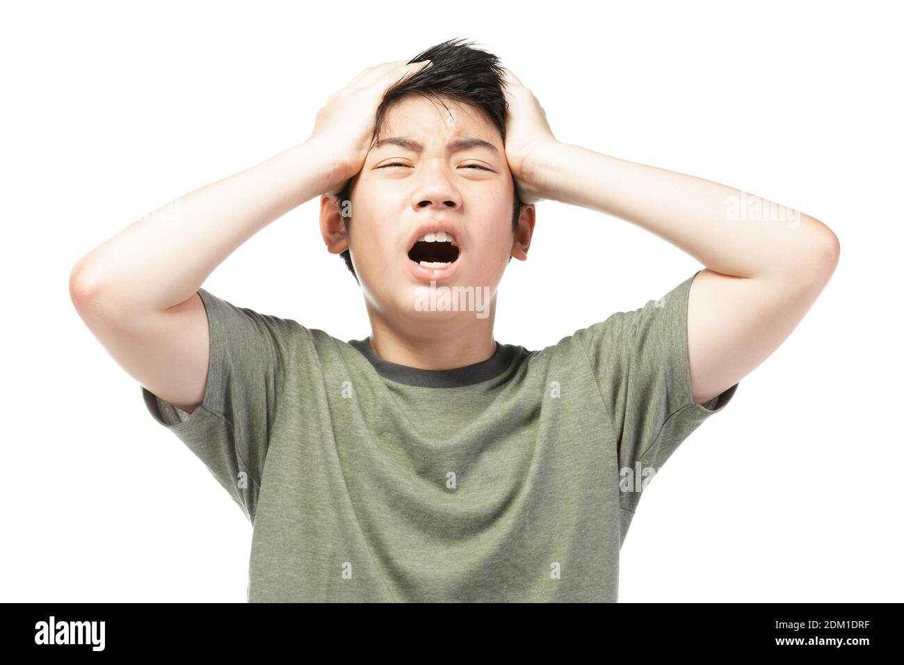 Angry Boy Standing Against White Background Stock Photo - Alamy