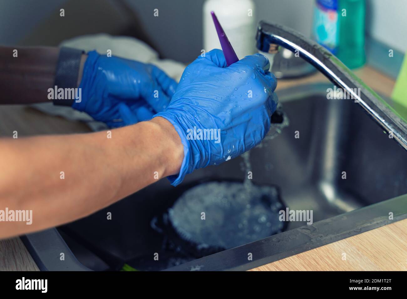 hairdresser washes hair dye container in the sink Stock Photo - Alamy