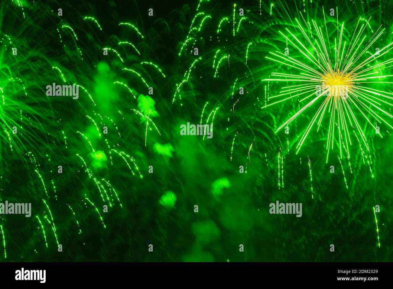 Vivid fireworks with glowing sparks in green colors. Explosive art ...