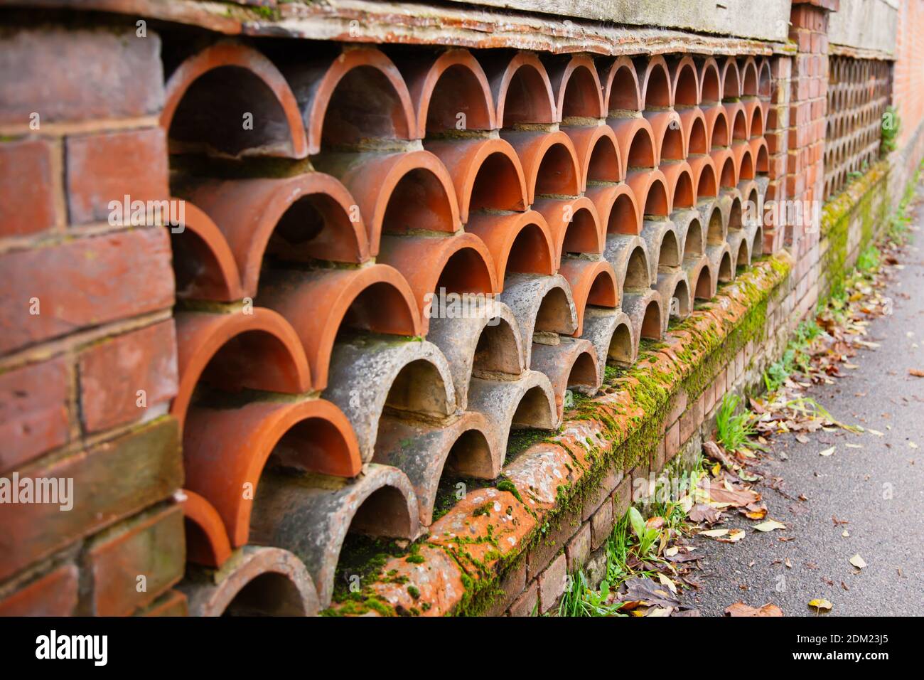 Arched ridge roof tiles forming a wall design Stock Photo - Alamy