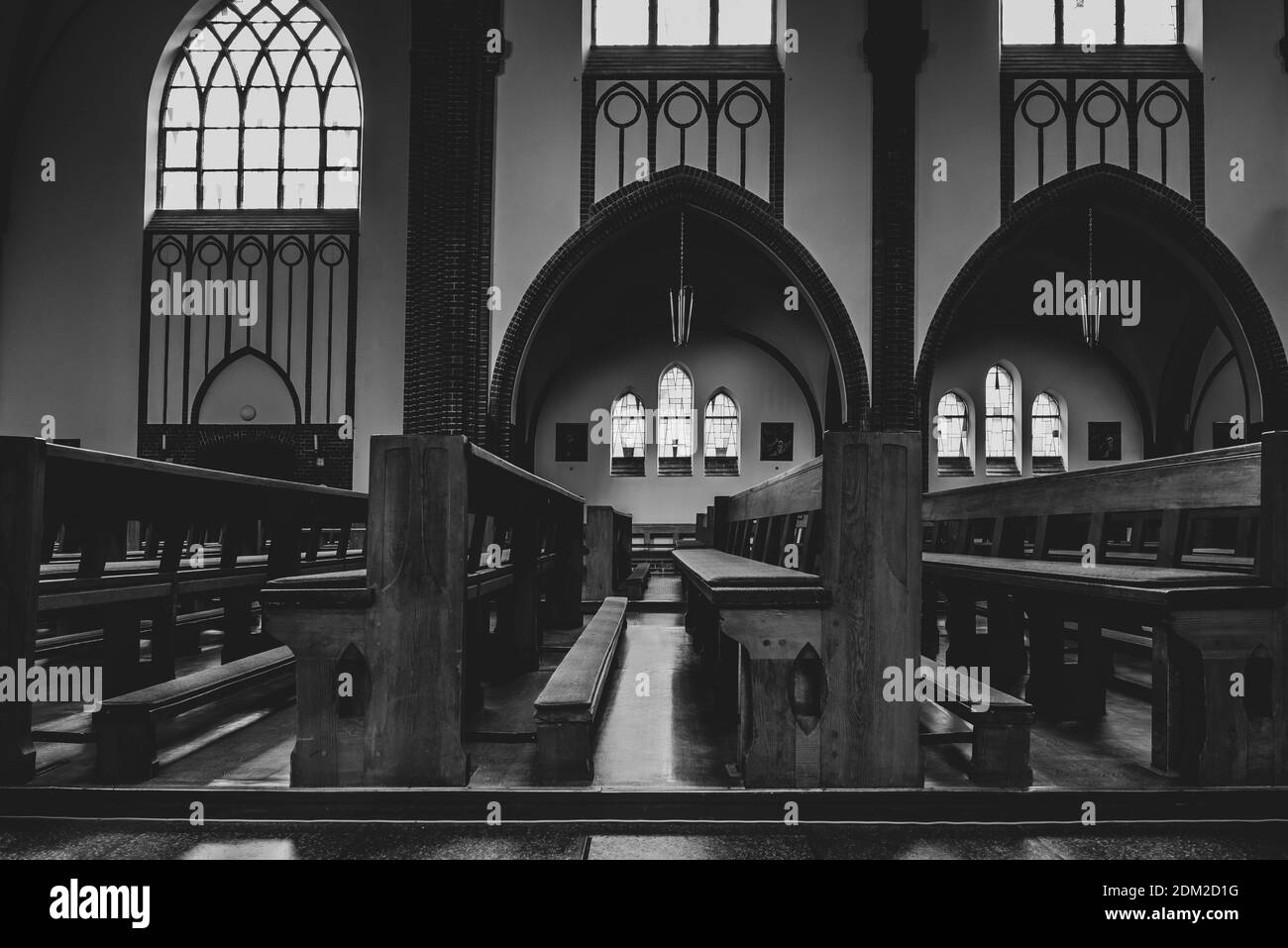 Empty benches in a church, empty prayer benches in a church, black and ...