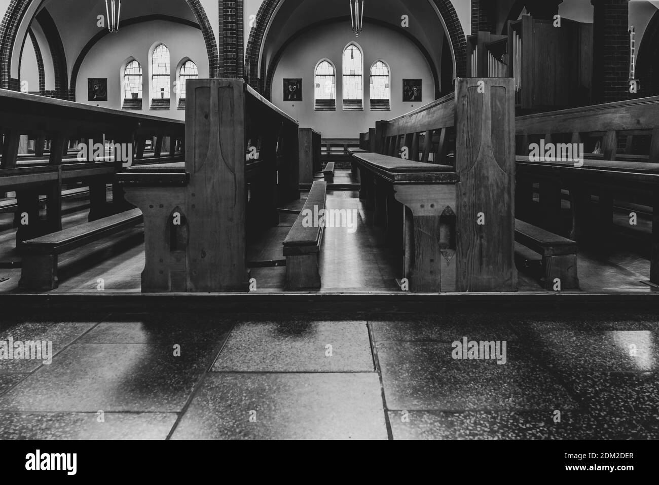 Empty benches in a church, empty prayer benches in a church, black and ...