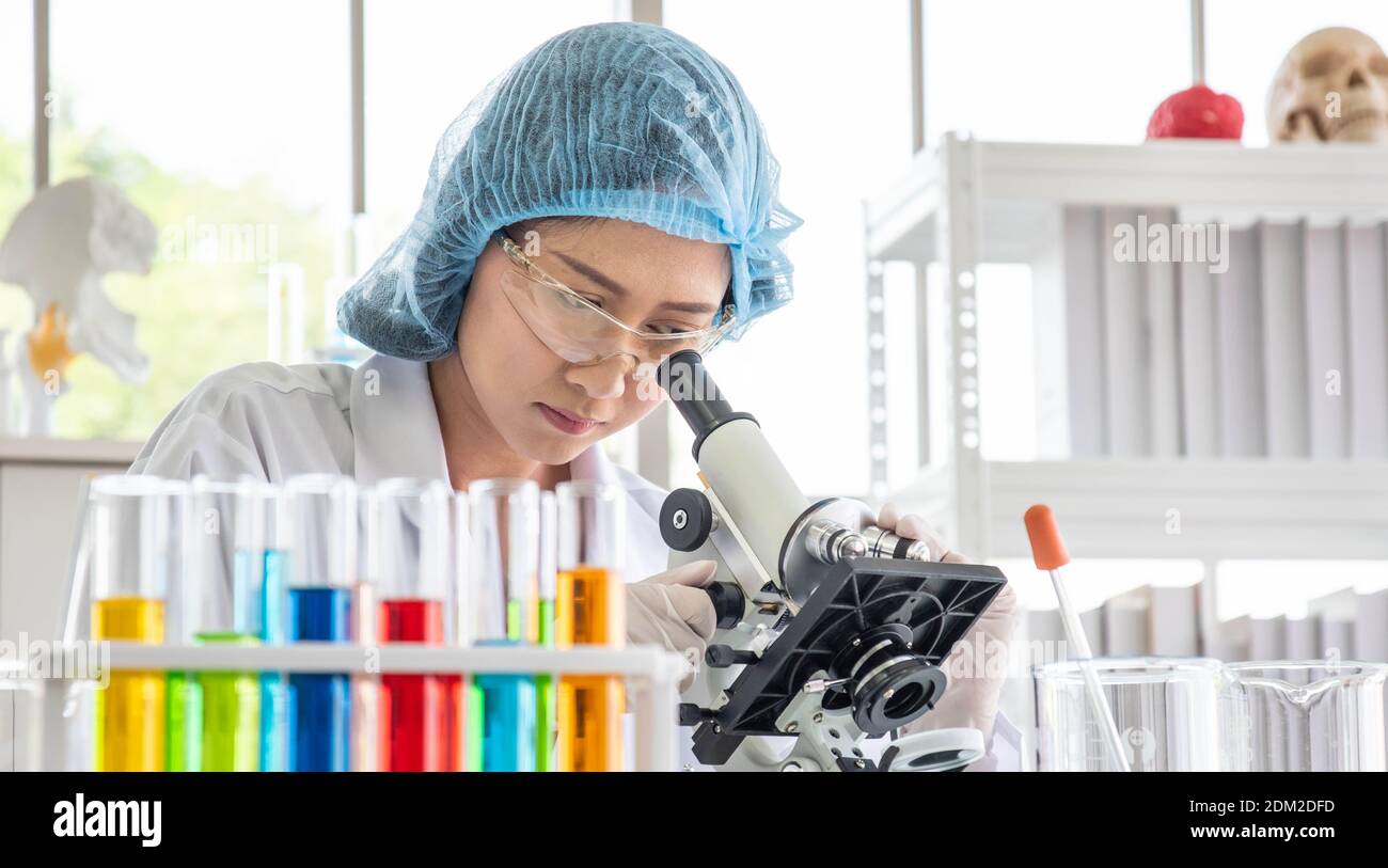 Female Scientist Looking Through Microscope At Laboratory Stock Photo ...