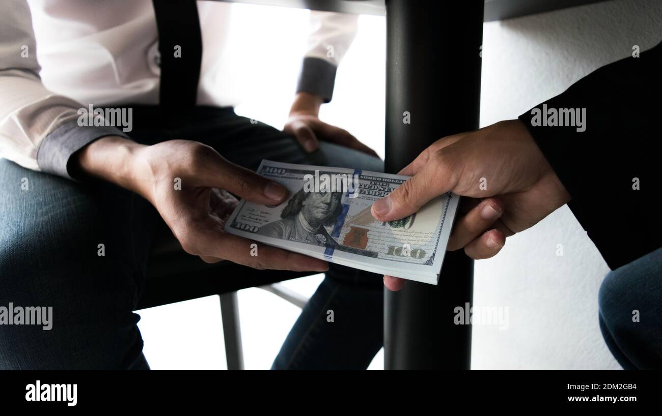 Money under table businessman hi-res stock photography and images - Alamy