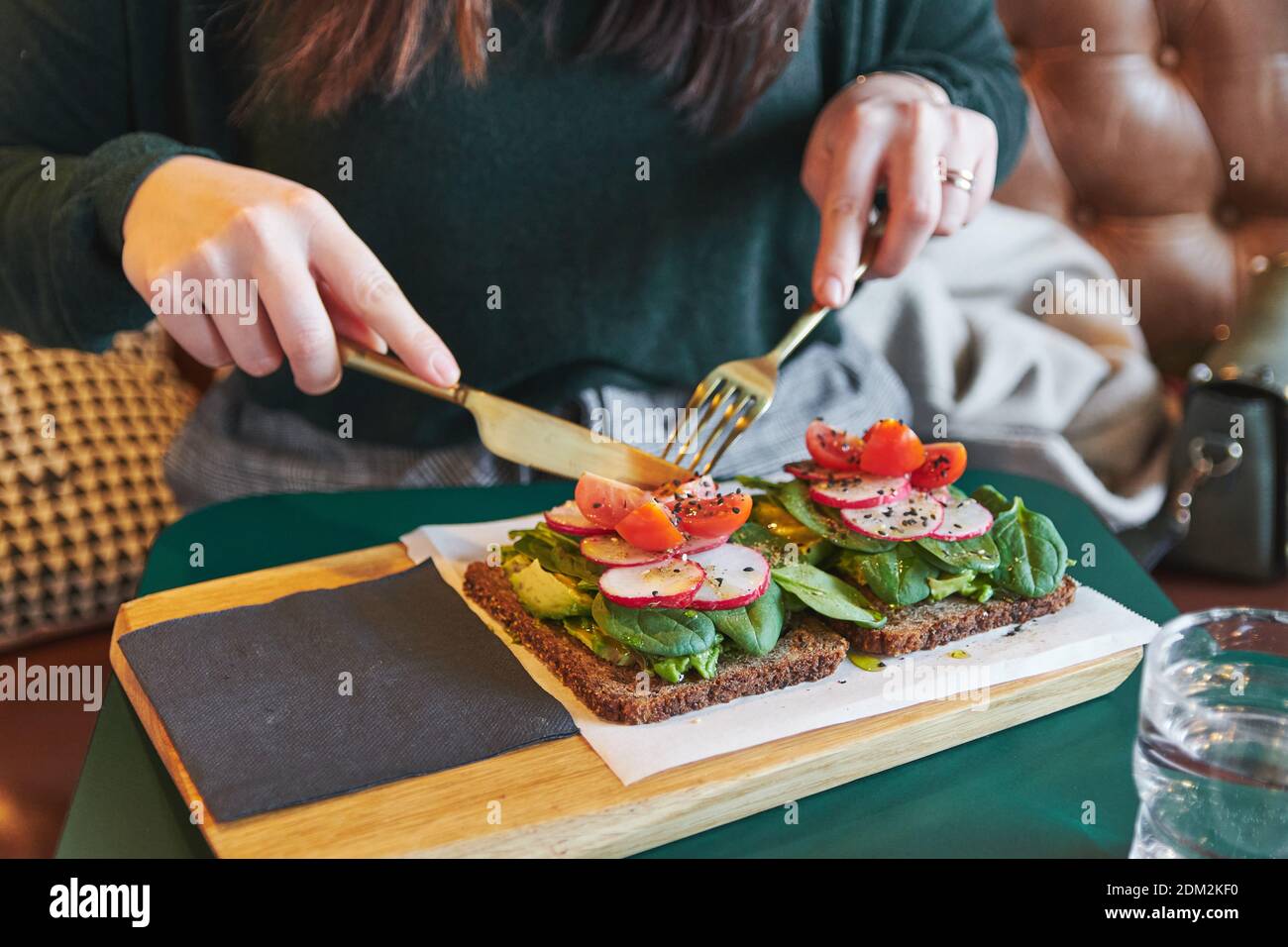 Hand eating avocado on toast hi-res stock photography and images - Alamy