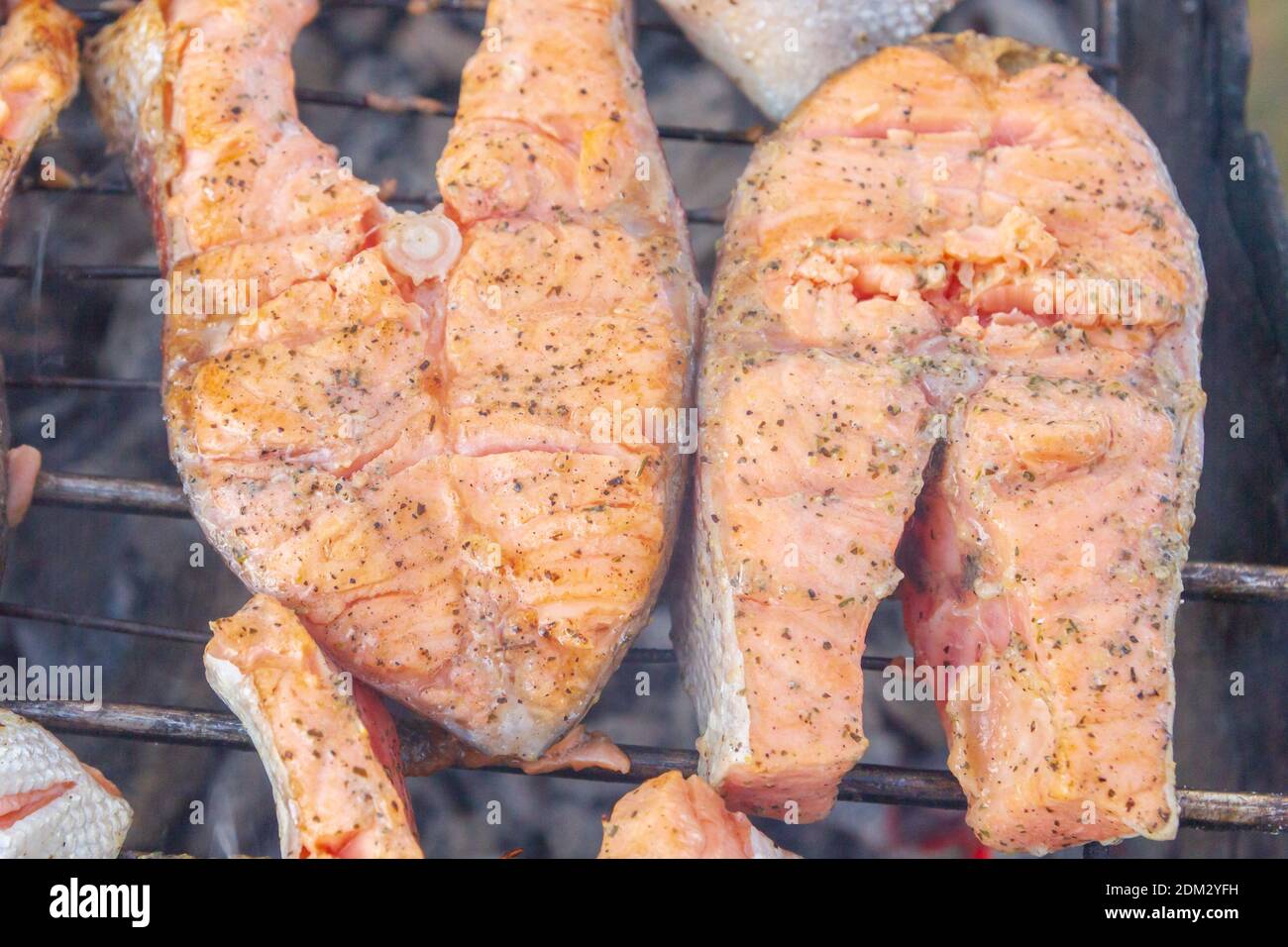 Large fish steaks fresh trout fried in spices on the grill Stock Photo ...