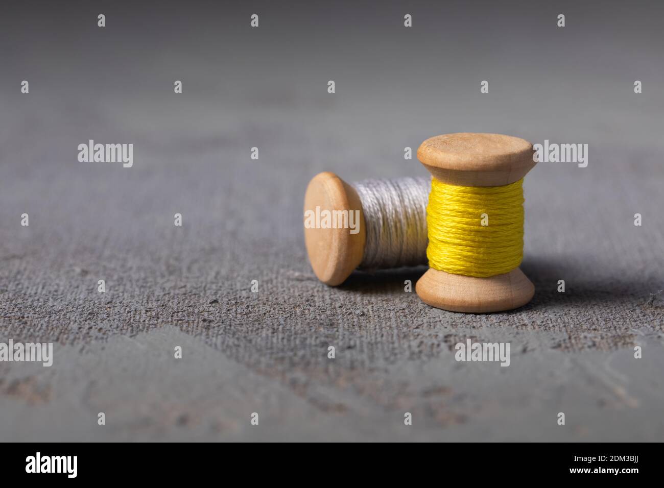 Trendy Illuminating Yellow and Ultimate grey colored threads wooden ...