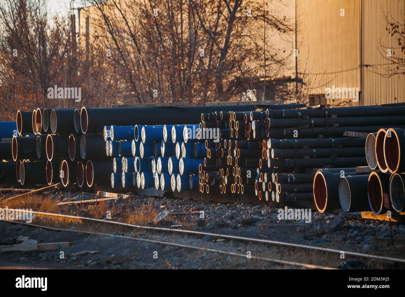 Stack of cast iron pipes in loading area waiting for transportation ...