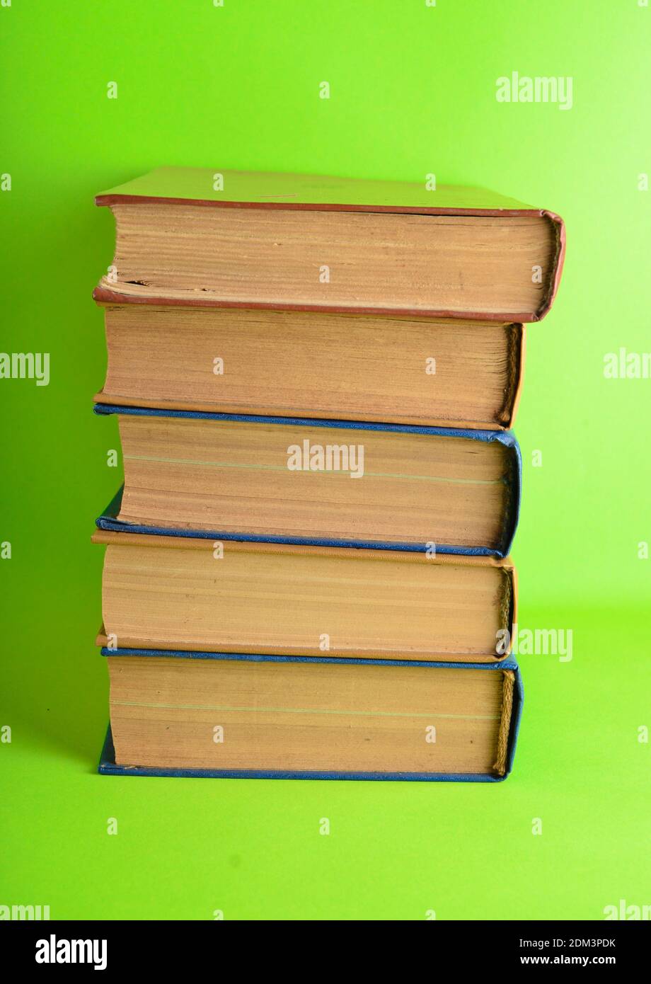 Stack of old books on a green background. Horizontal photo Stock Photo ...