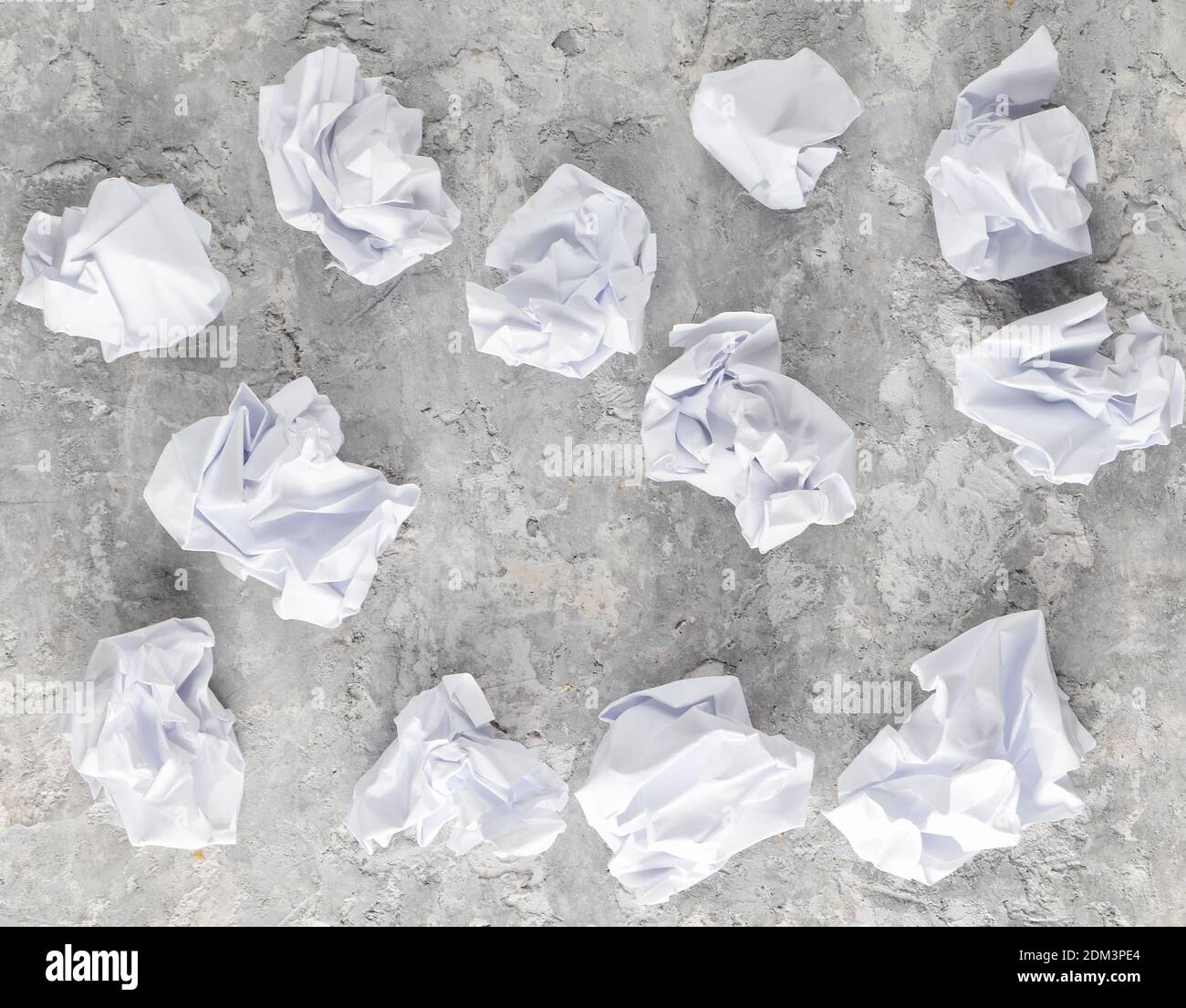 Balls of crumpled paper on a gray concrete surface Stock Photo - Alamy
