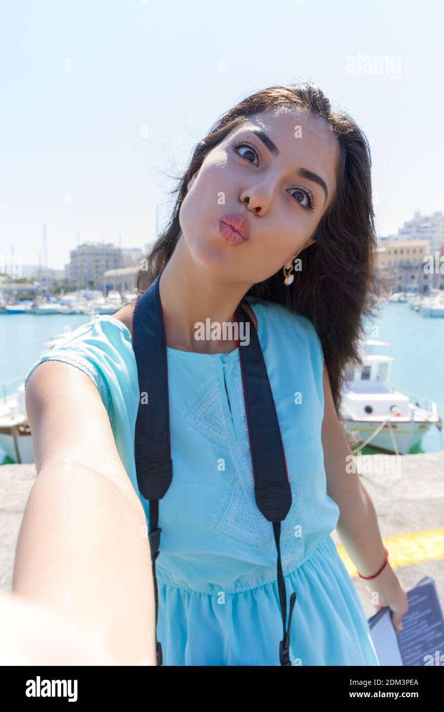 Happy woman taking self-portrait photo in Heraklion, Crete, Greece ...
