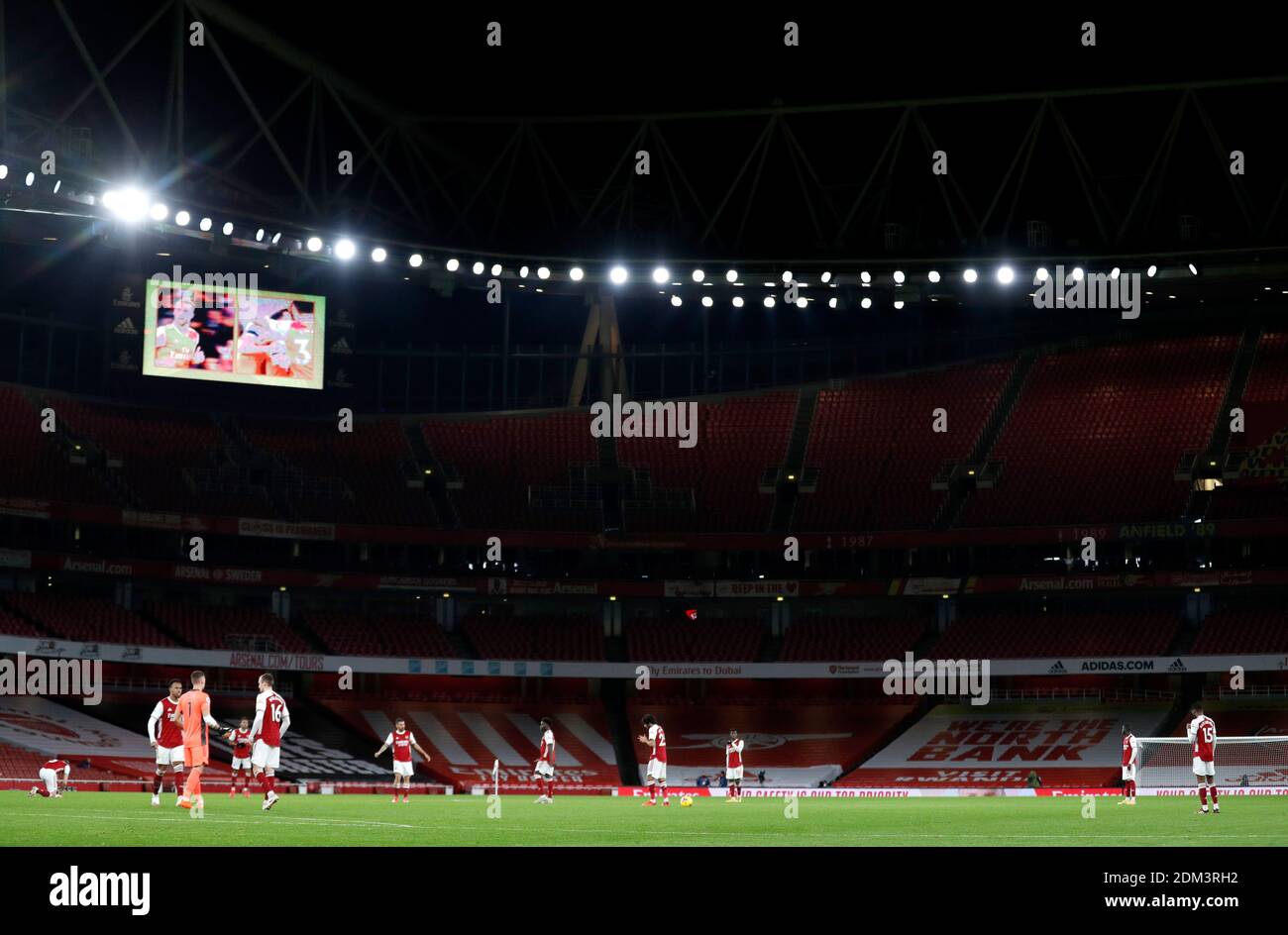 Arsenal players ahead of the start of the second half in an empty ...