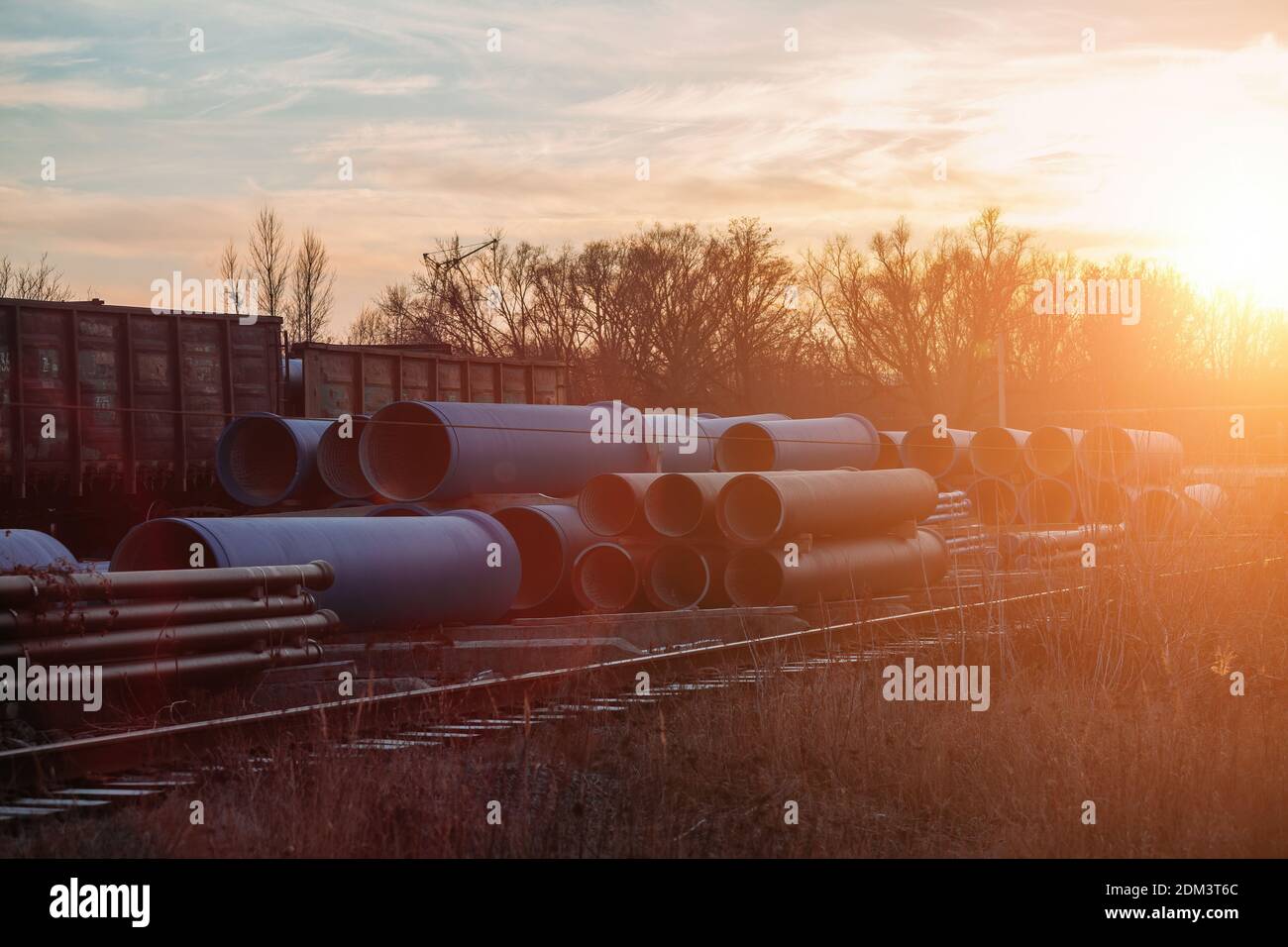 Stack of cast iron pipes in loading area waiting for transportation ...