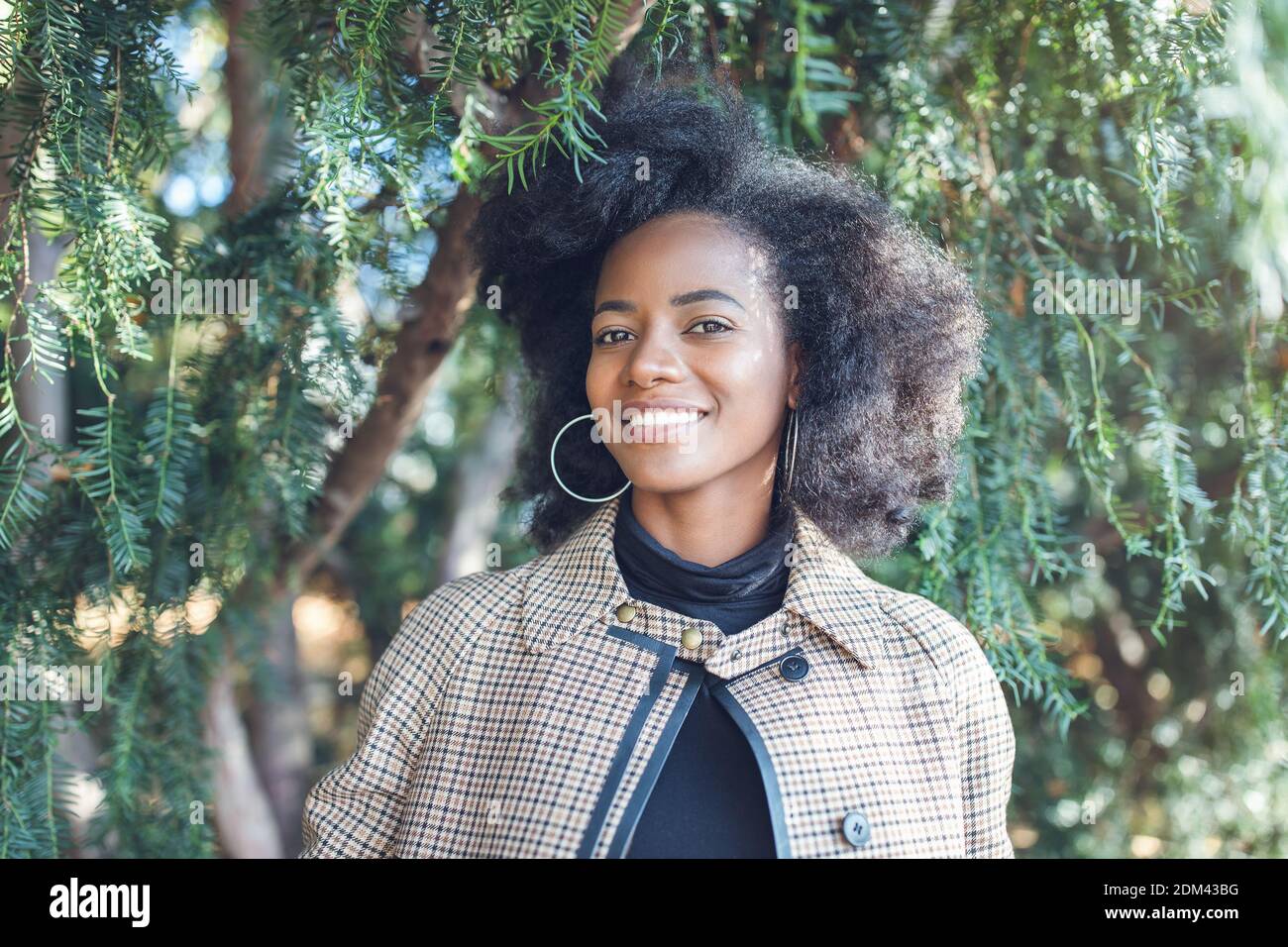 Beautiful African American woman in a spring park Stock Photo - Alamy
