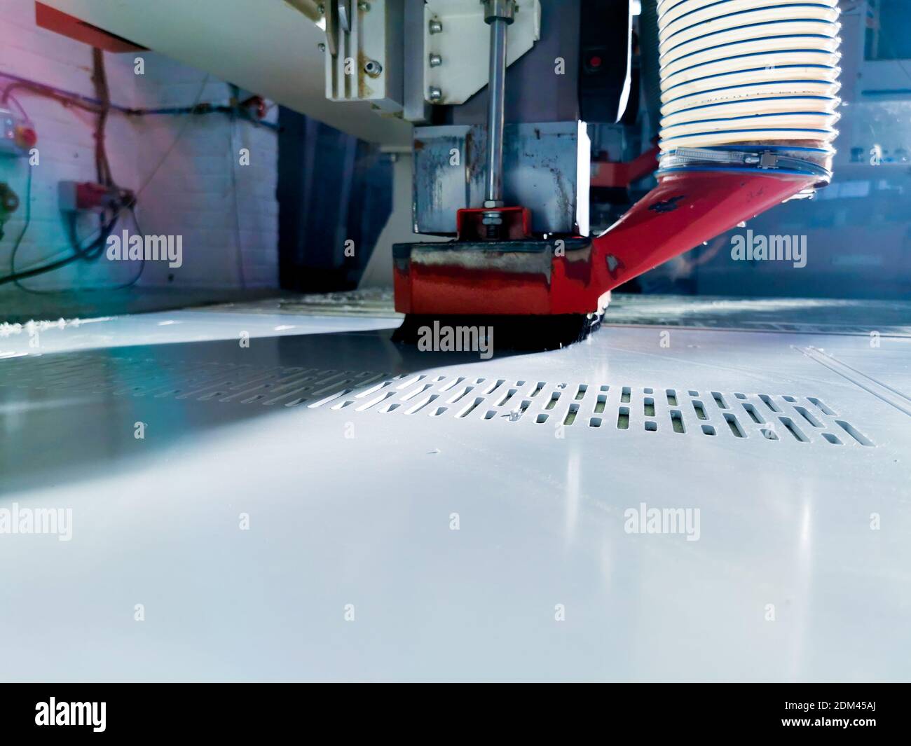 General view of a CNC machine cutting through a Polyethylene board in a ...
