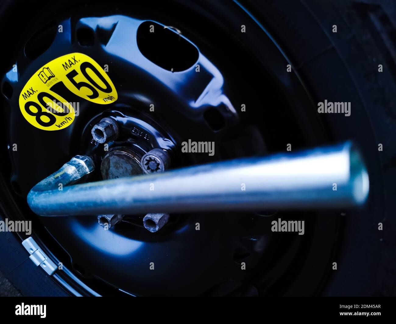 Spare wheel being installed on a car after a puncture in the original ...