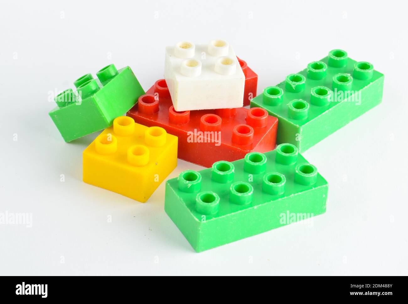 Colorful toy bricks of a children's designer on a white background ...