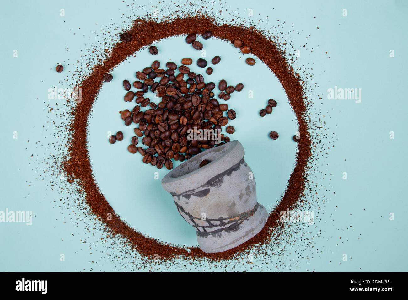 Roasted whole coffee grain on a mexican stone mortar surrounded by a ...