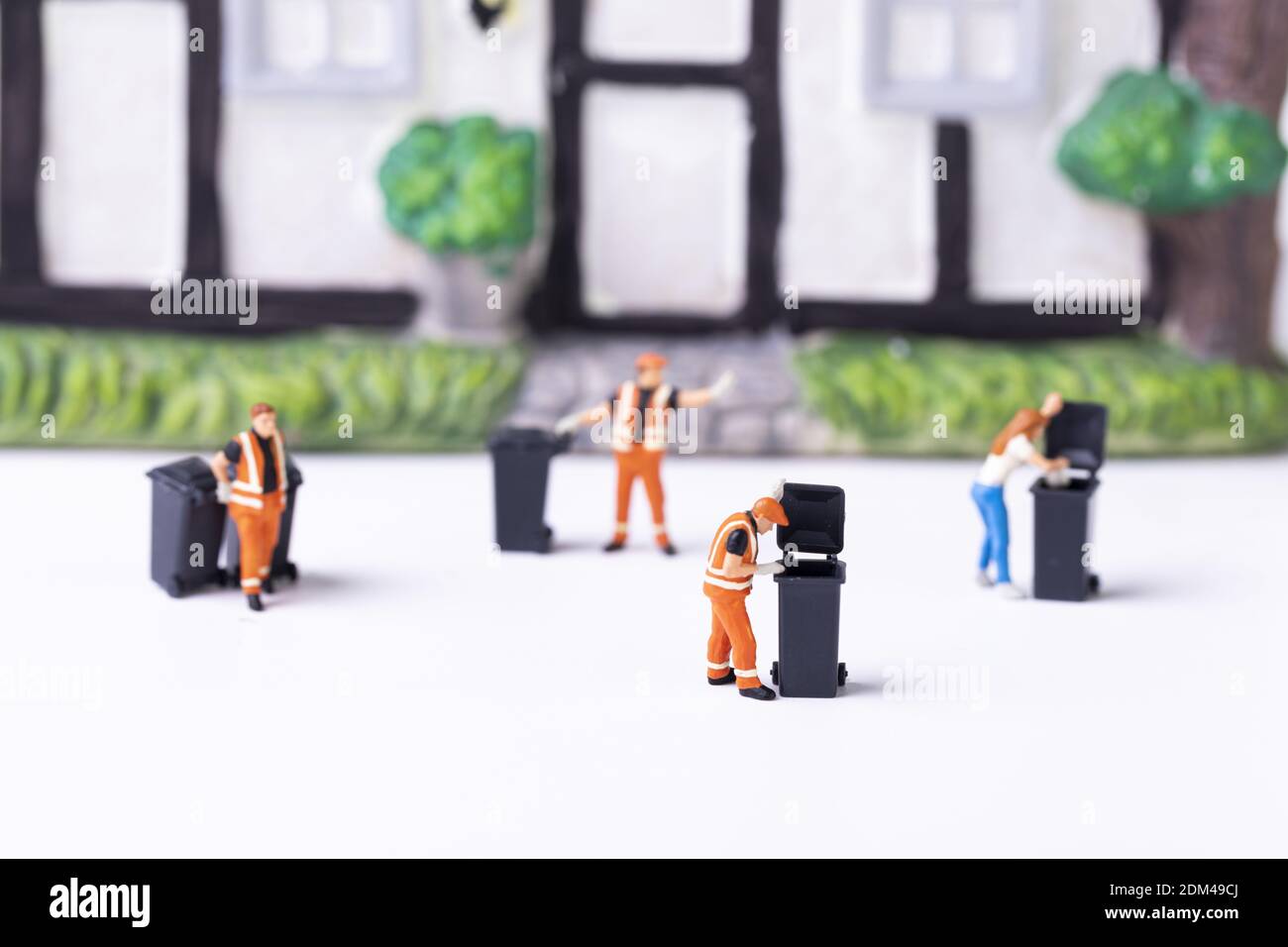 A selective focus shot of a lady throwing garbage and waste collector ...